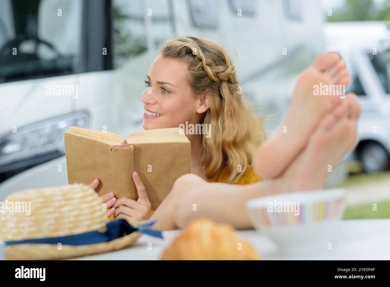 woman reading her book in the campervan campsite Stock Photo - Alamy