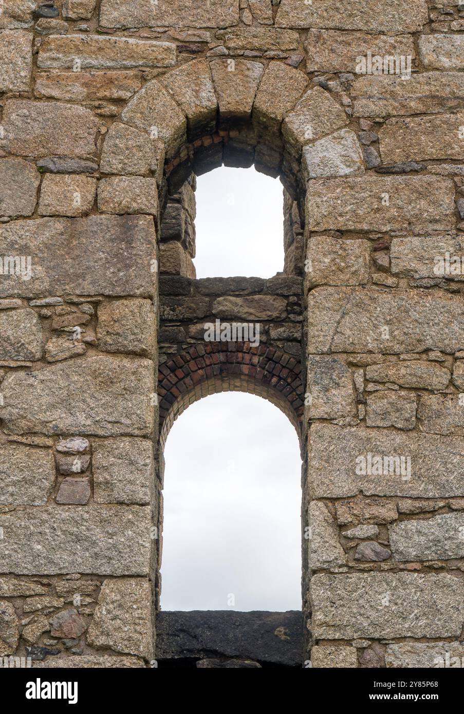 Roman arch in wall of old Cornish tin mine engine house constructed ...