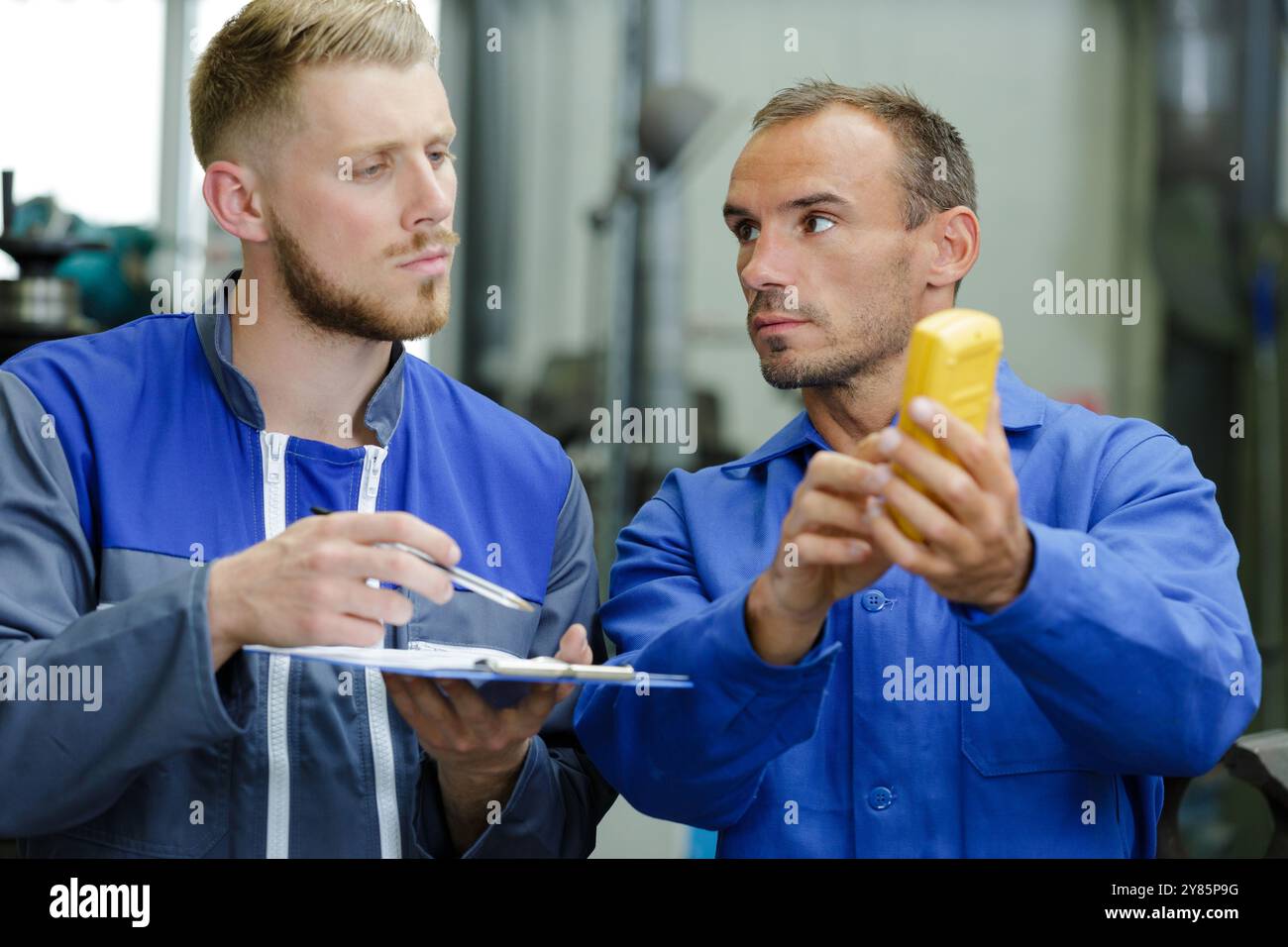 a mechanic man with digital multimeter testing ignition coil Stock ...