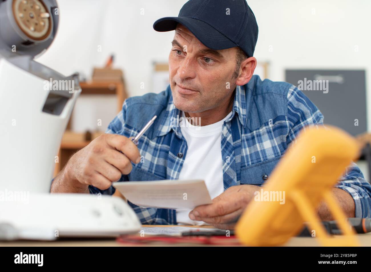 electrician using a multimeter at workplace Stock Photo - Alamy