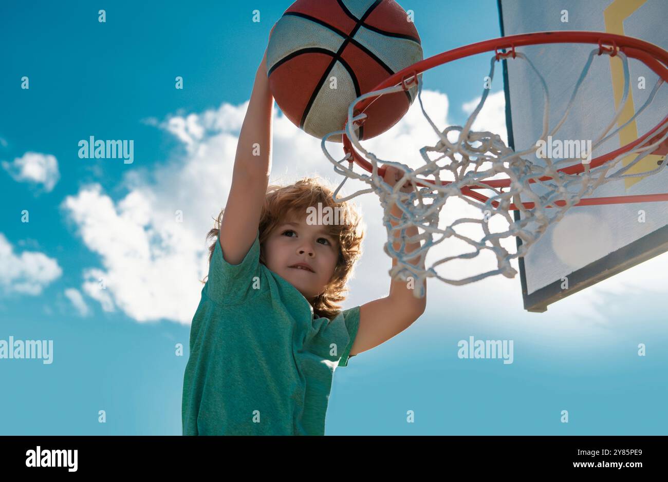 Basketball kid player dunking the ball. Child basketball player making ...