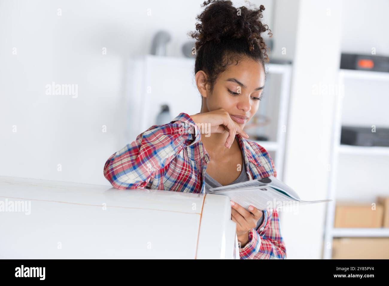 Woman reading an instruction manual hi-res stock photography and images ...