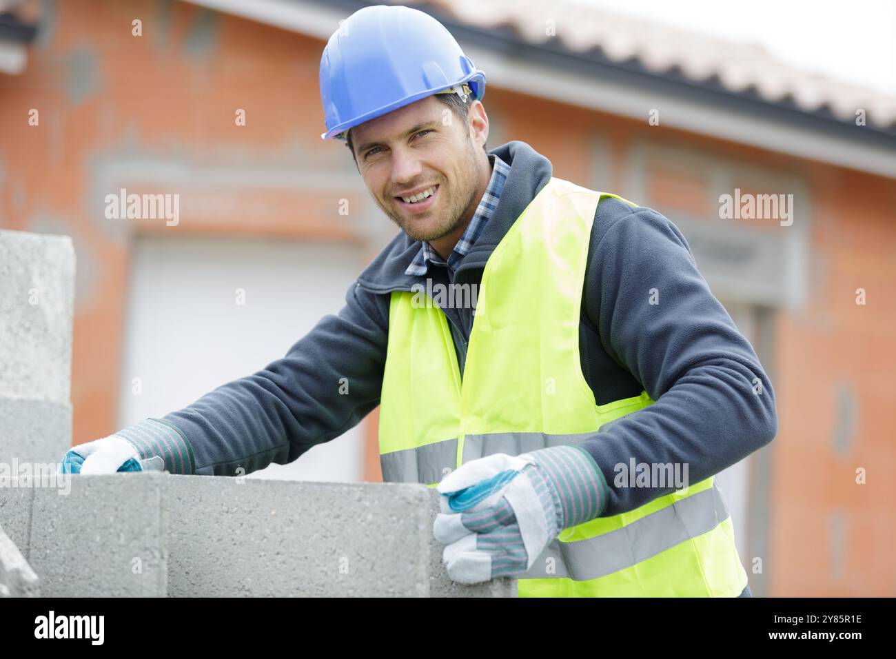 the man-builder works with concrete Stock Photo - Alamy