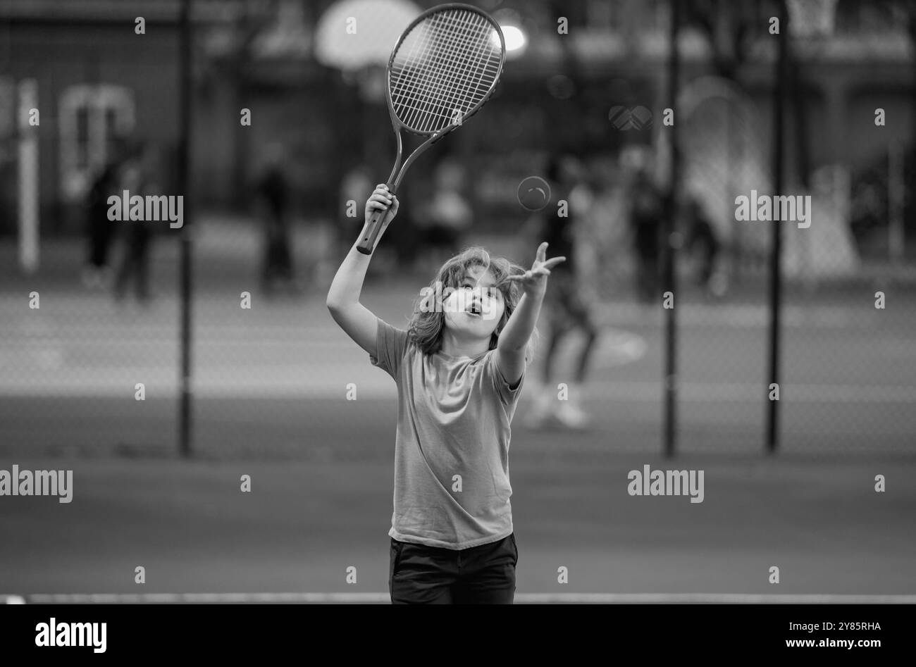 Cute Kid play tennis. Little kid hit tennis ball with tennis racket ...
