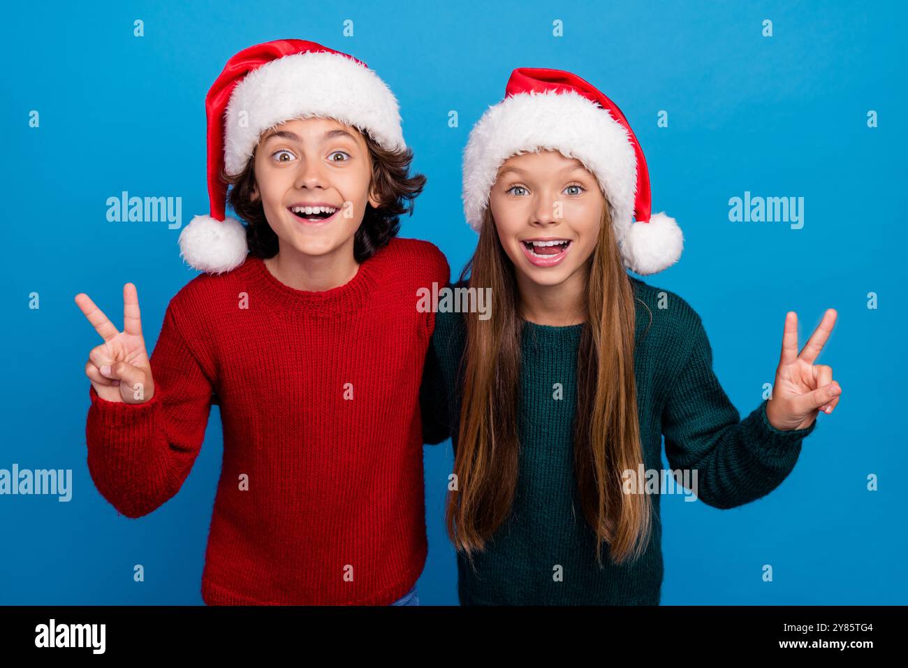 Photo of two people kids boy girl hug make v sign isolated blue color ...