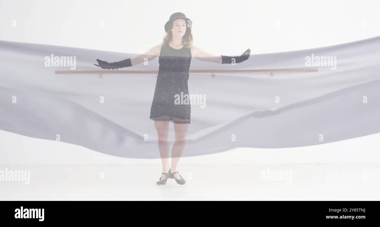 Image of caucasian woman dancing over floating cloth on white ...