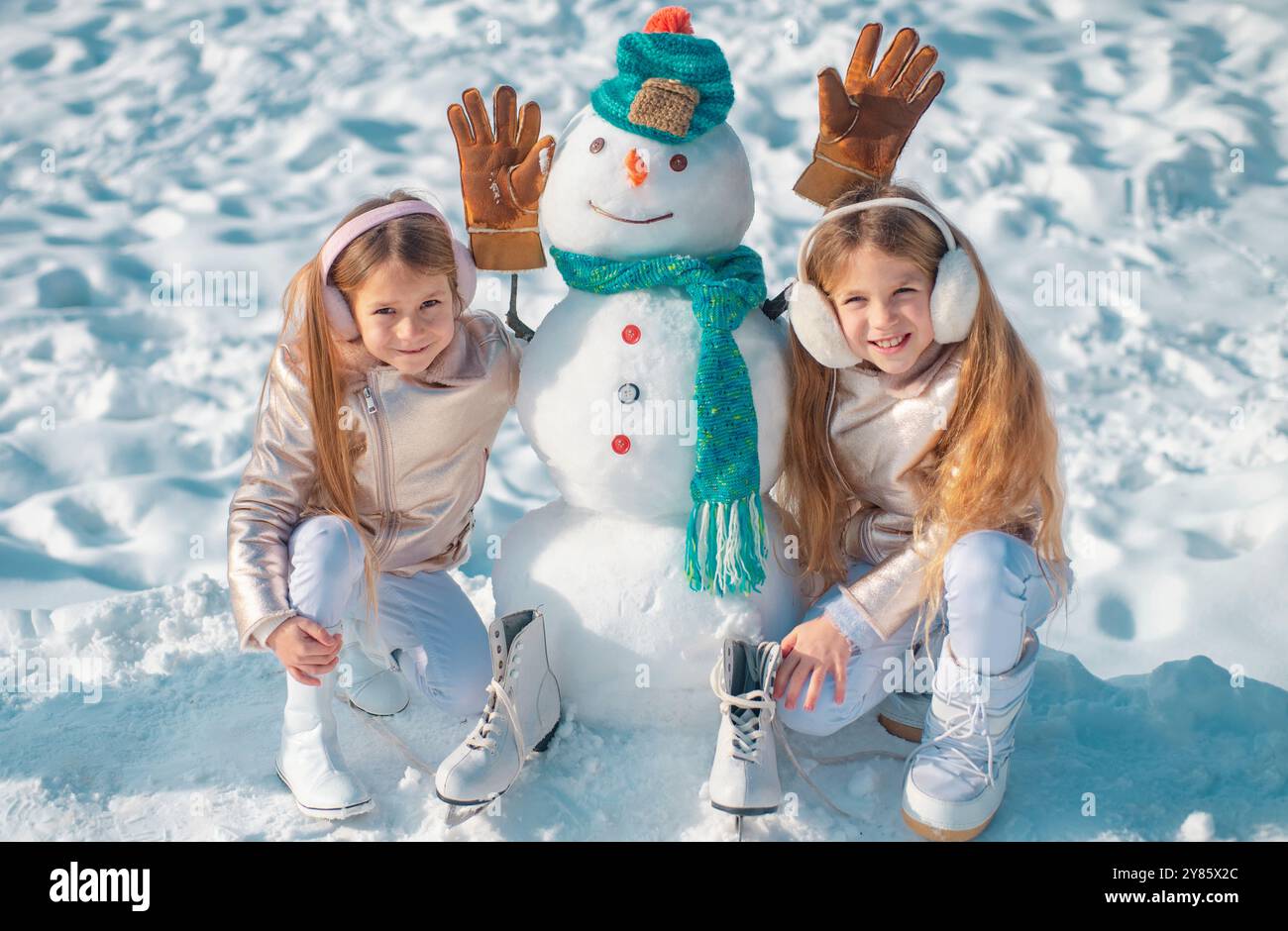 Making snowman and winter fun for children. Happy children playing with ...