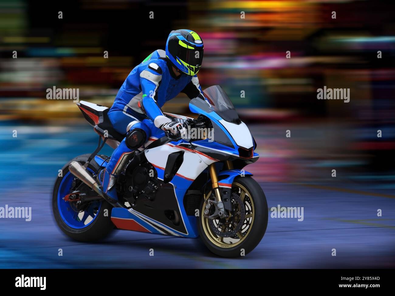 Motorcycle rider in helmet and gear racing at high speed in blue colors ...