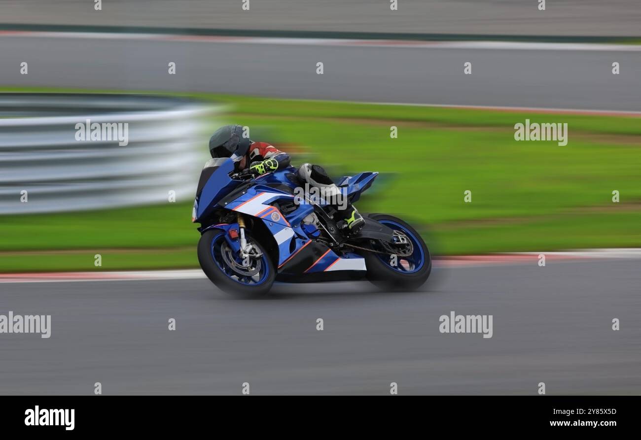 Racing bike rider leaning into a fast corner at high speed on the race ...