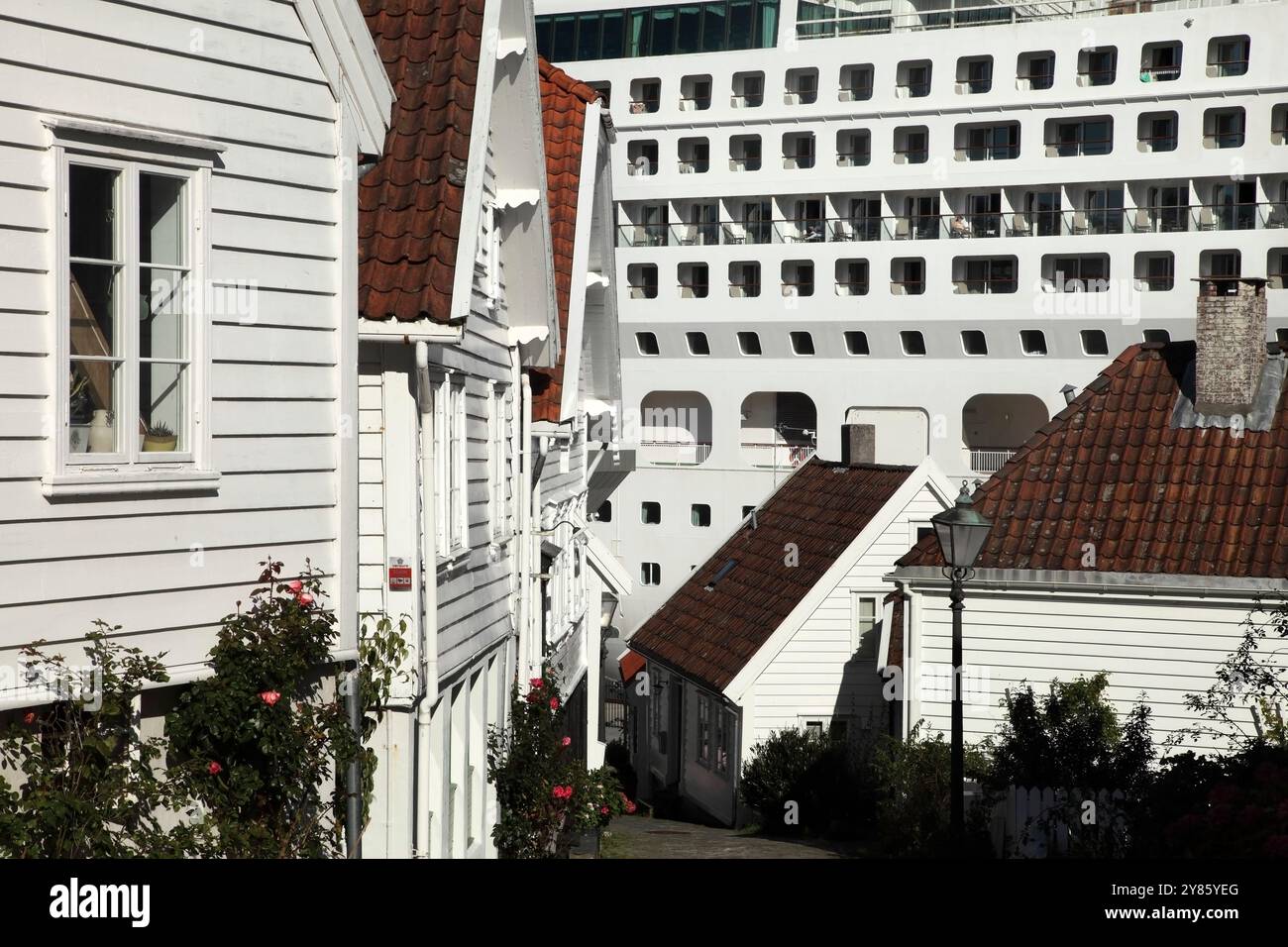 The P&O cruise ship "Aurora" moored close to traditional timber housing ...