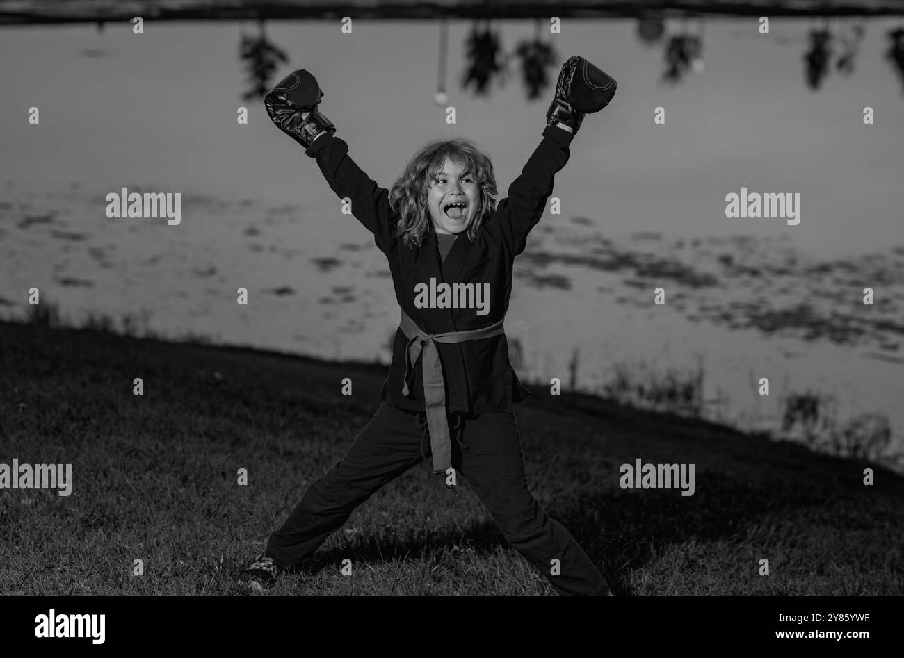 Excited little karate fighter. Kid boy practicing karate outdoor. Sport ...