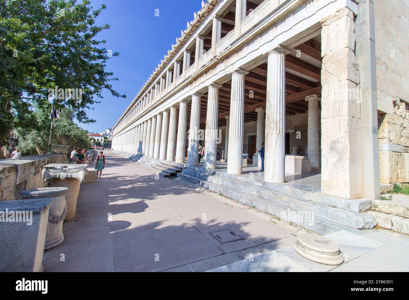 A beautiful woman standing at columns of Housing the Museum of the ...