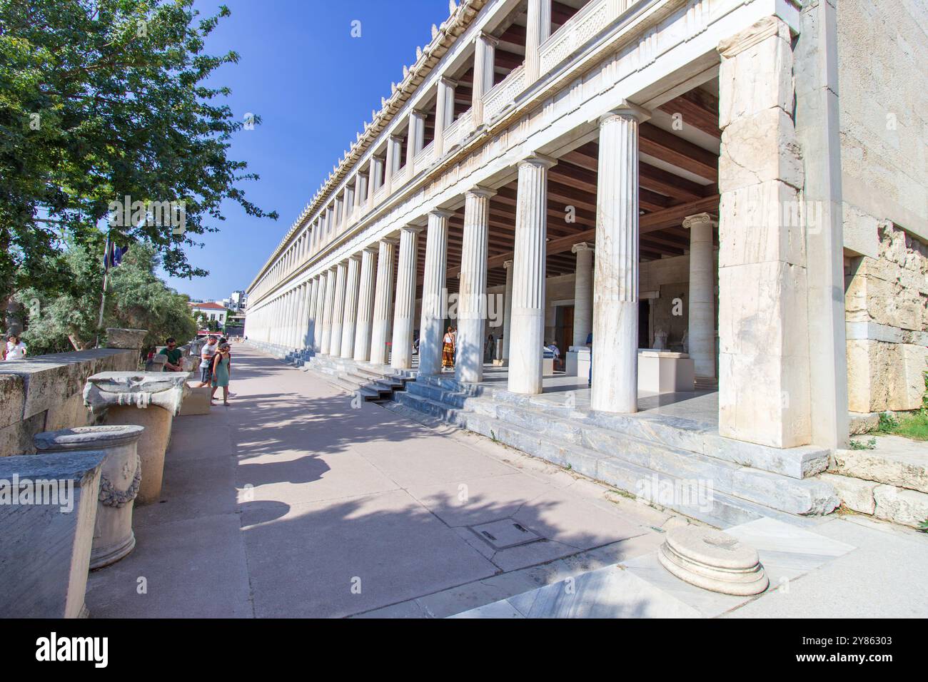 A beautiful woman standing at columns of Housing the Museum of the ...