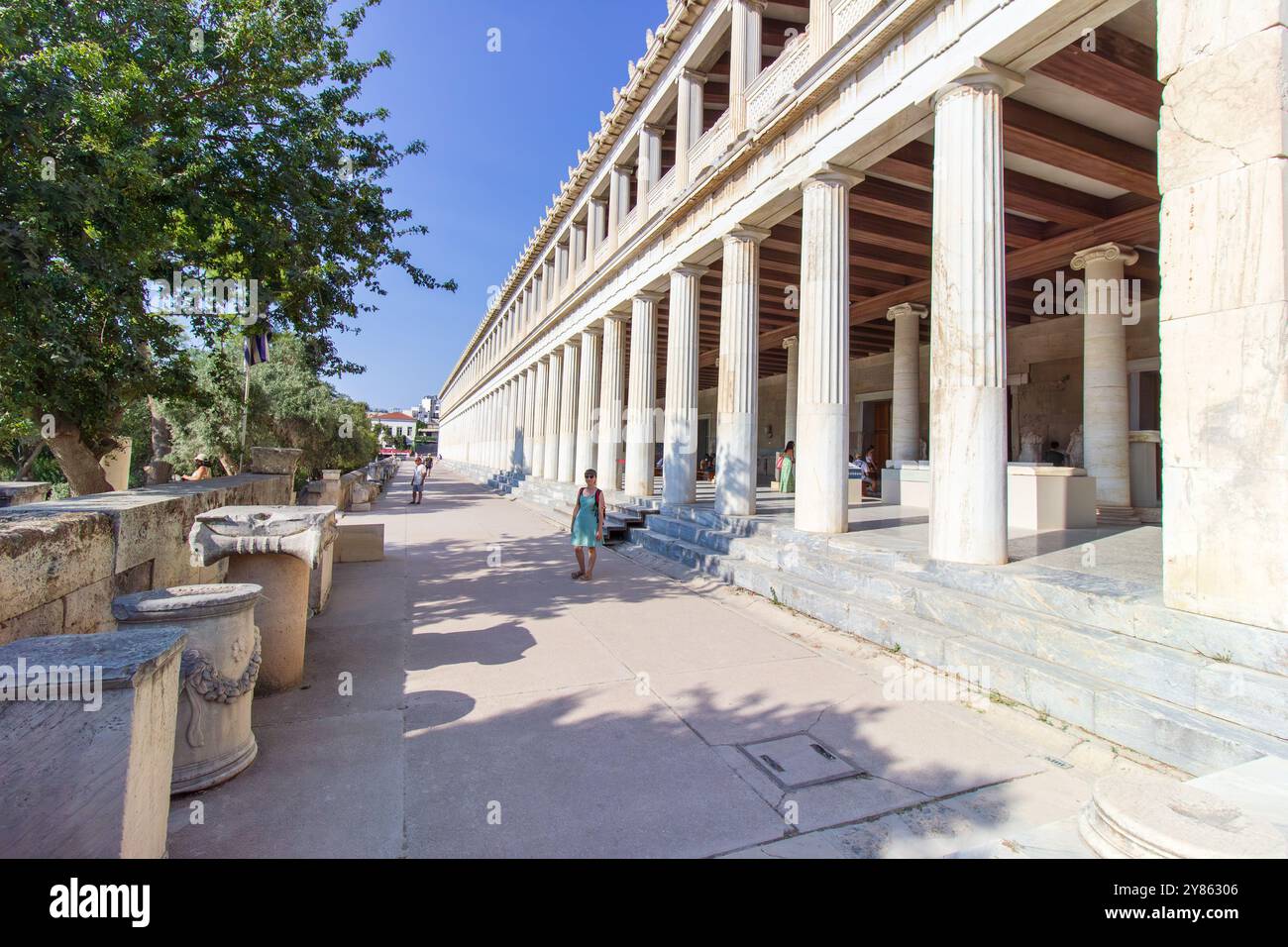 A beautiful woman standing at columns of Housing the Museum of the ...