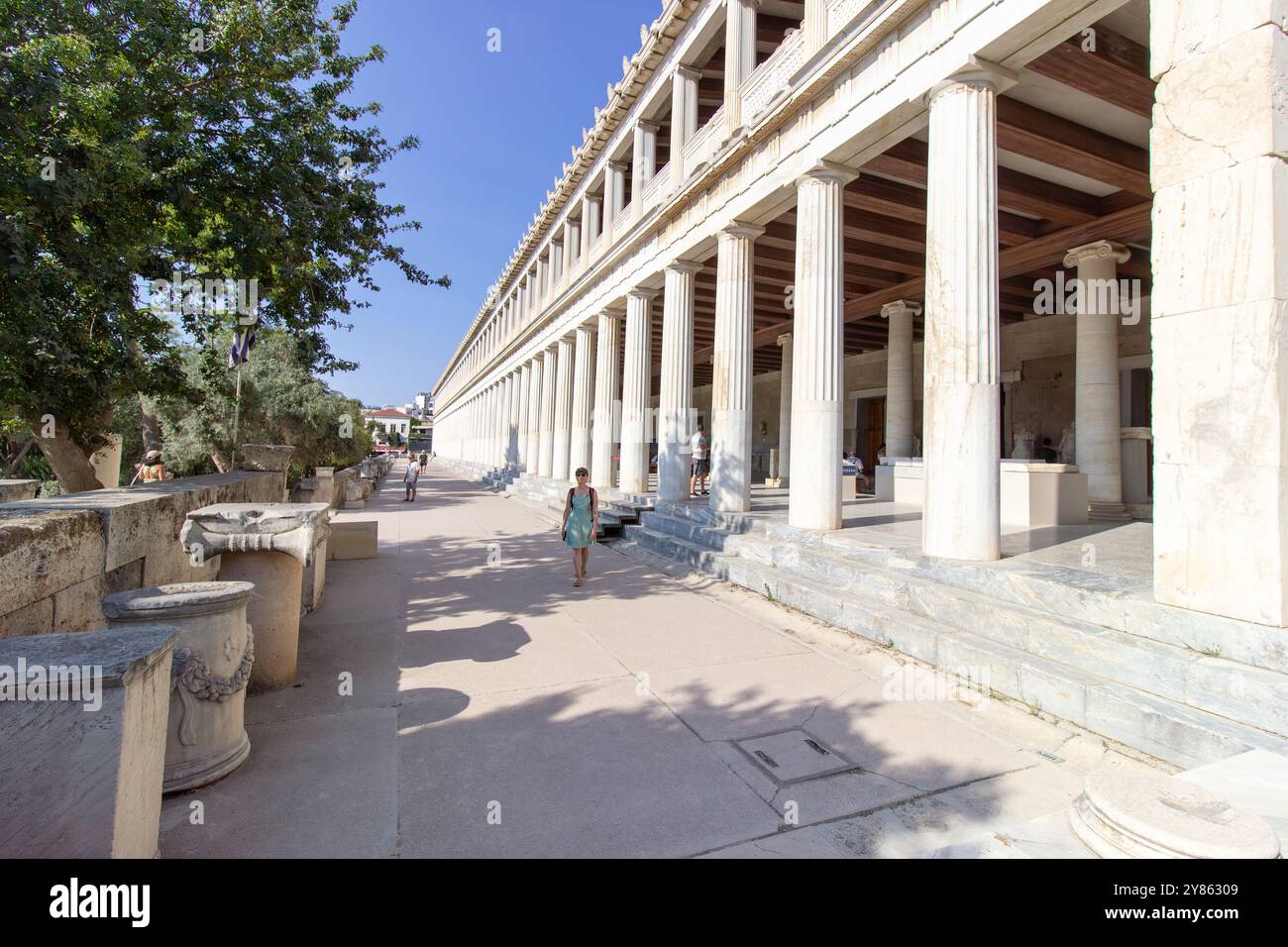 A beautiful woman standing at columns of Housing the Museum of the Ancient Agora. Stoa of ...