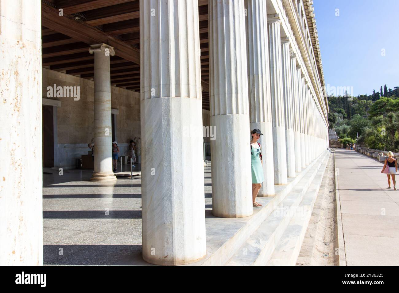 A beautiful woman standing at columns of Housing the Museum of the ...