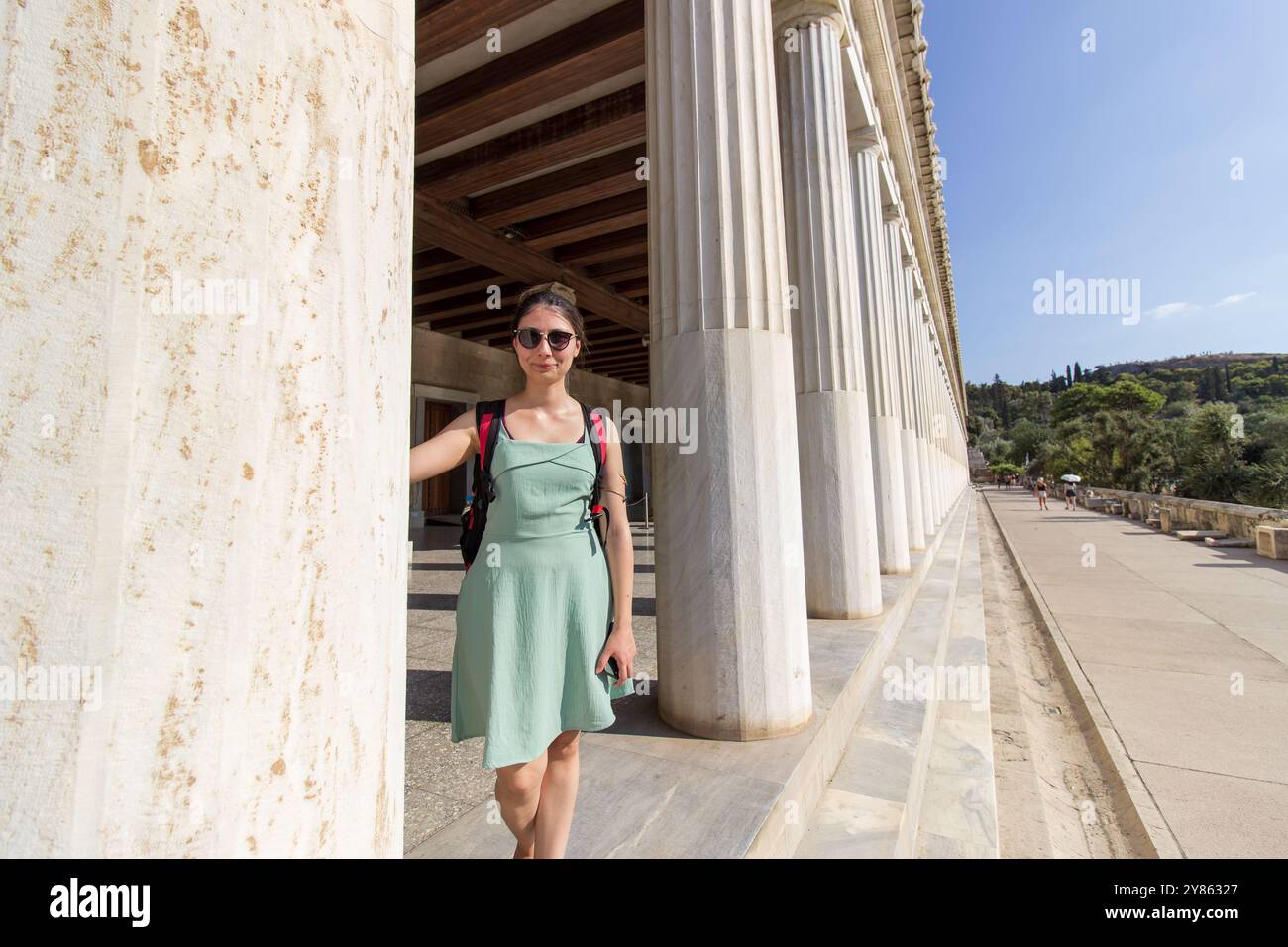 A beautiful woman standing at columns of Housing the Museum of the ...