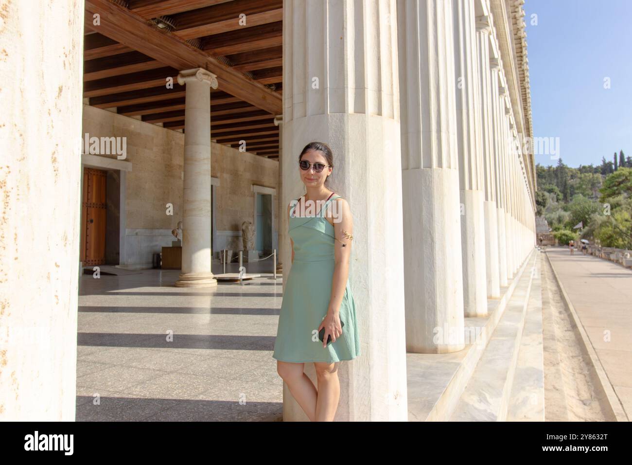 A beautiful woman standing at columns of Housing the Museum of the Ancient Agora. Stoa of ...