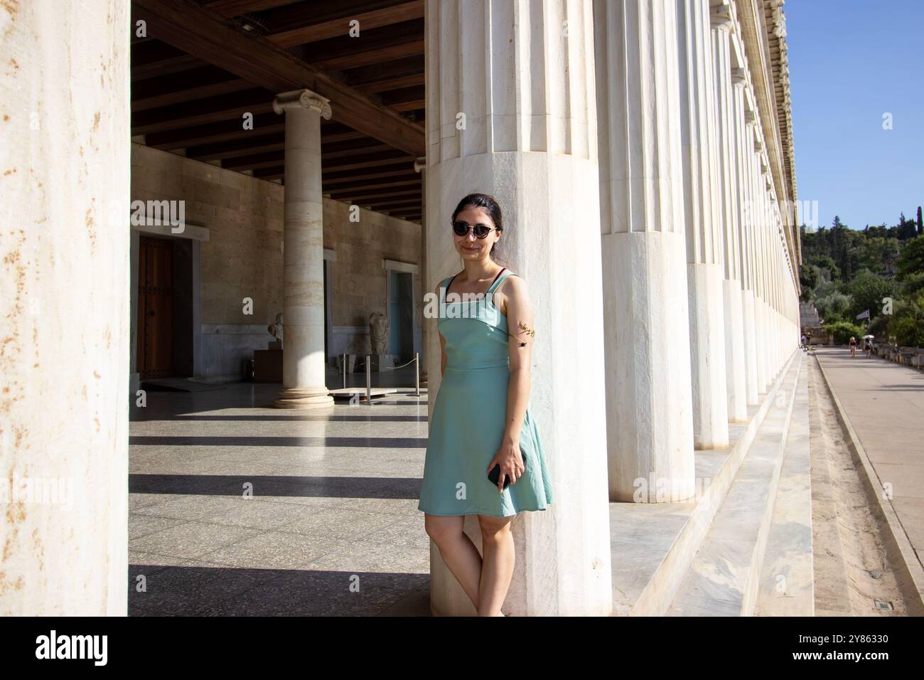 A beautiful woman standing at columns of Housing the Museum of the Ancient Agora. Stoa of ...