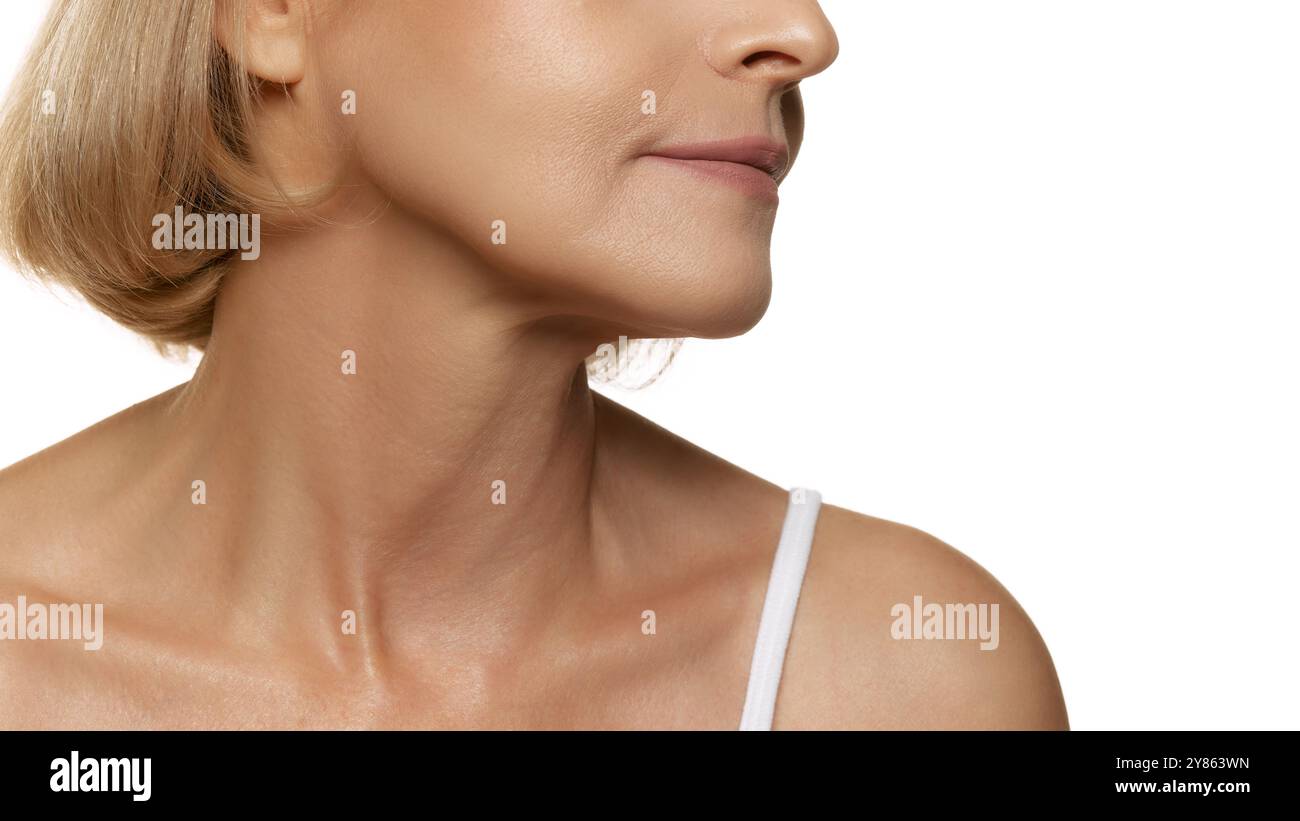 Radiant close-up of woman's smile, slightly turned to side, emphasizing ...