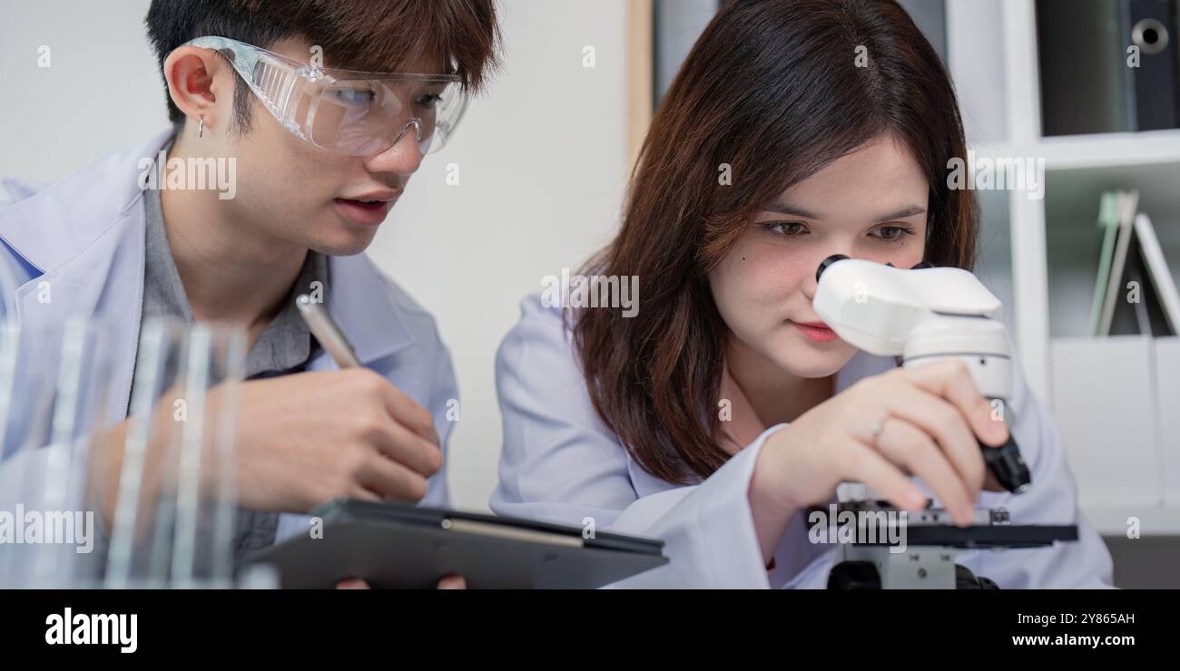 Young Scientists Collaborating in Laboratory for Microscopic Analysis ...