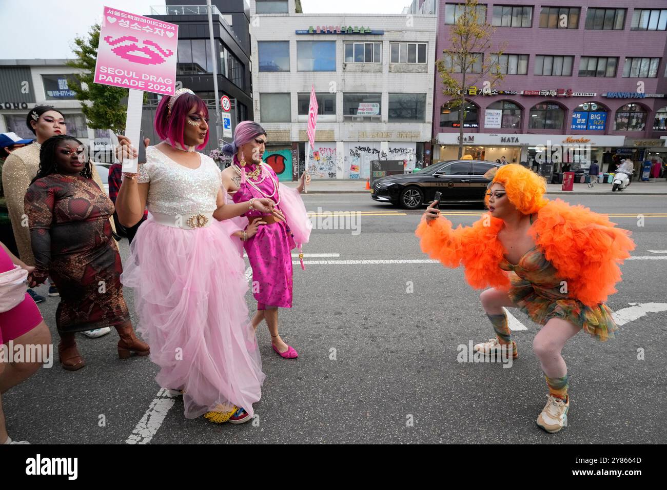 A participant dressed as drag takes a photo during Seoul Drag Parade in ...