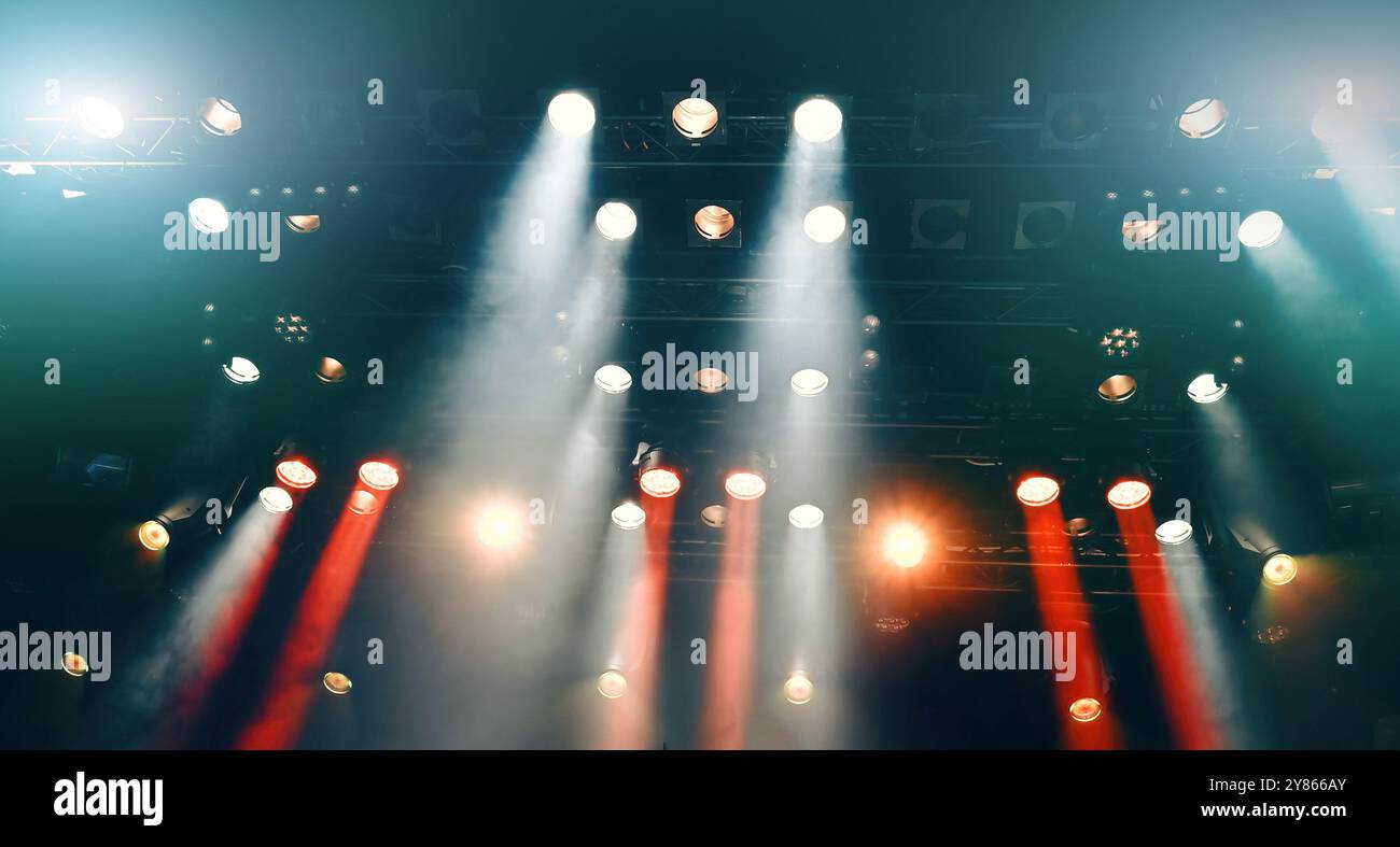 glowing ceiling spotlights lights the stage during the concert with ...