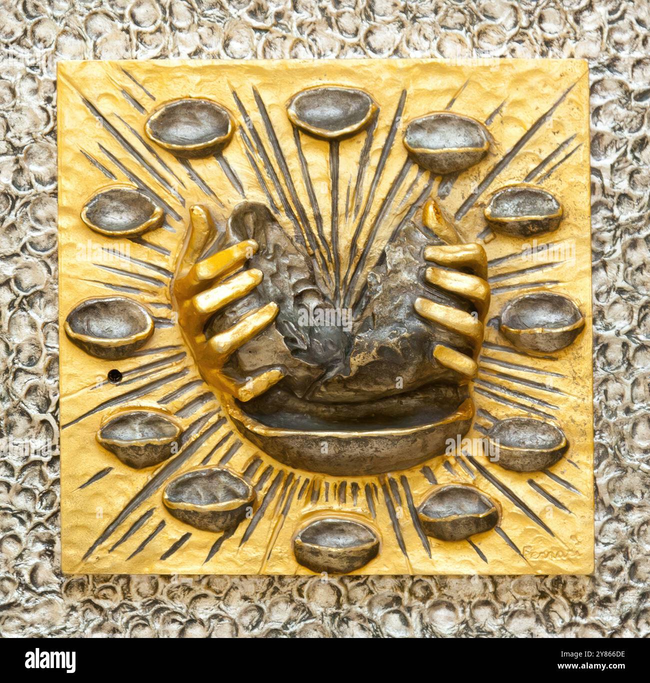 Bronze bas relief showing two hands holding open a broken heart ...