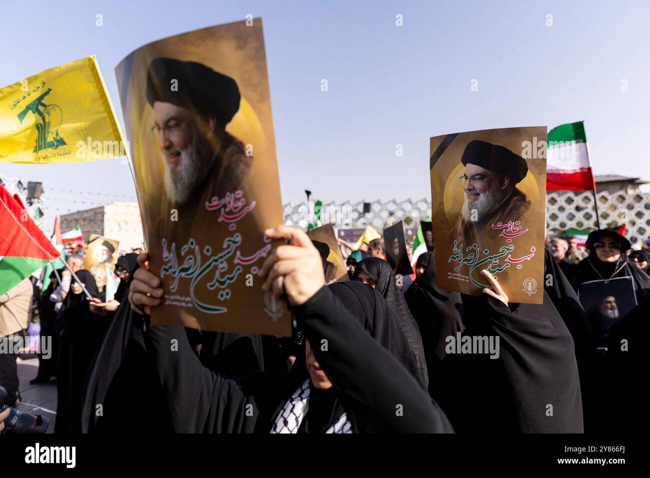 An Iranian demonstrator holds a poster of slain Hezbollah leader Hassan ...
