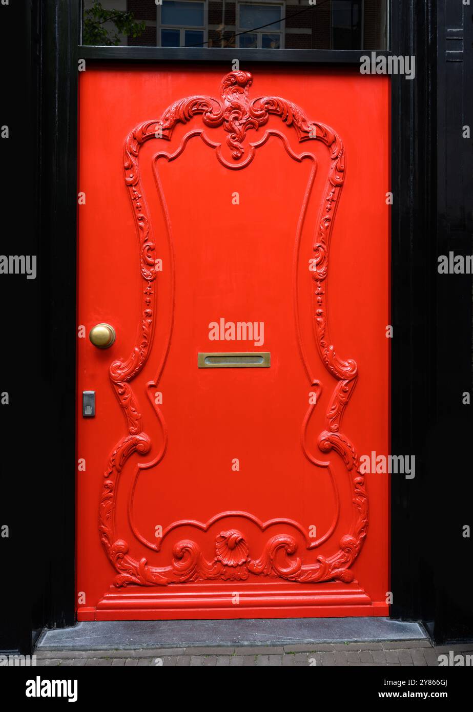 Vintage red door with design in residential building. House entrance in ...