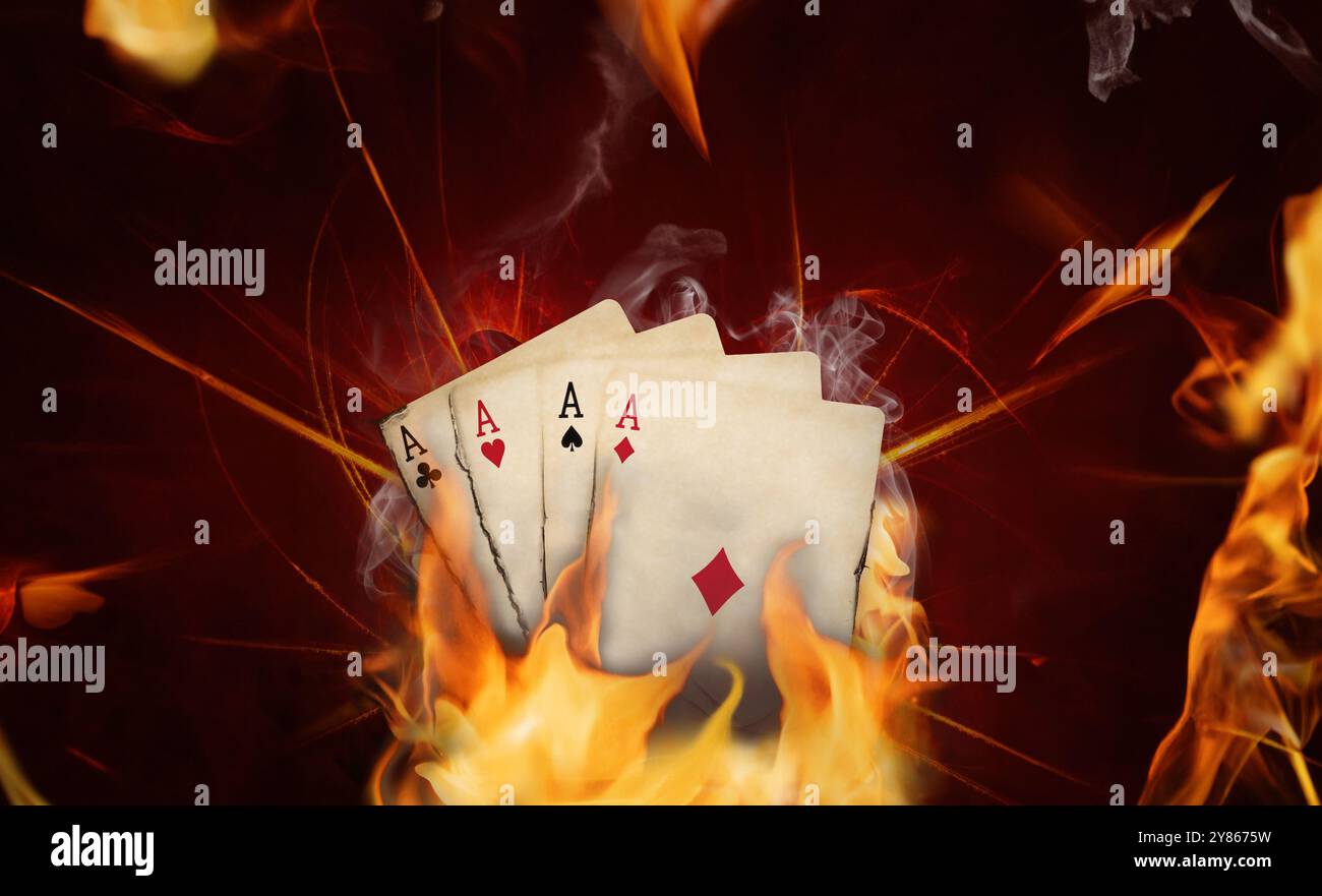 Four aces playing cards are burning in bright fire flames against a ...