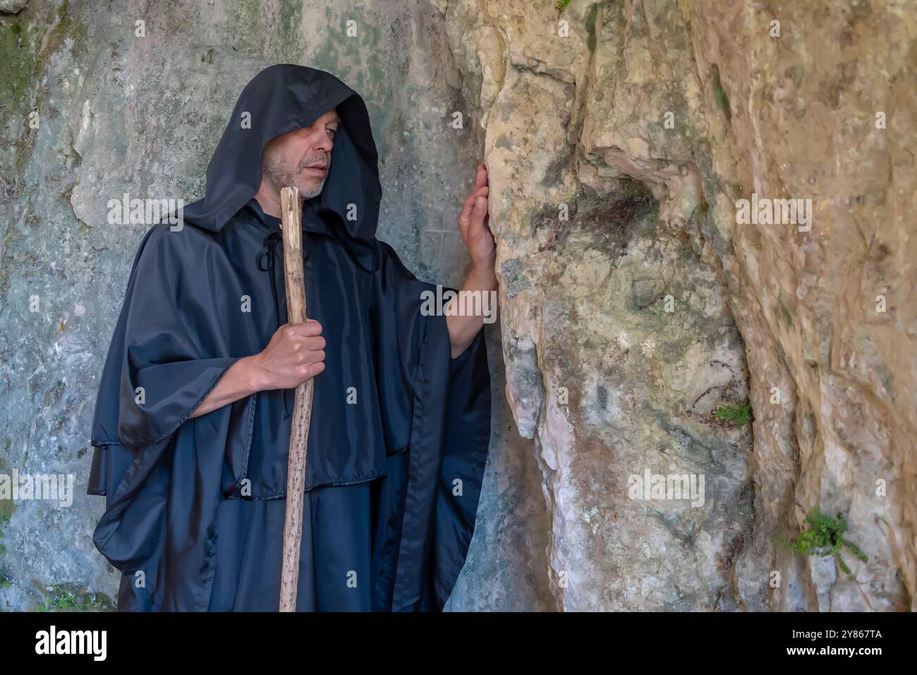 Elderly monk in black cloak hi-res stock photography and images - Alamy