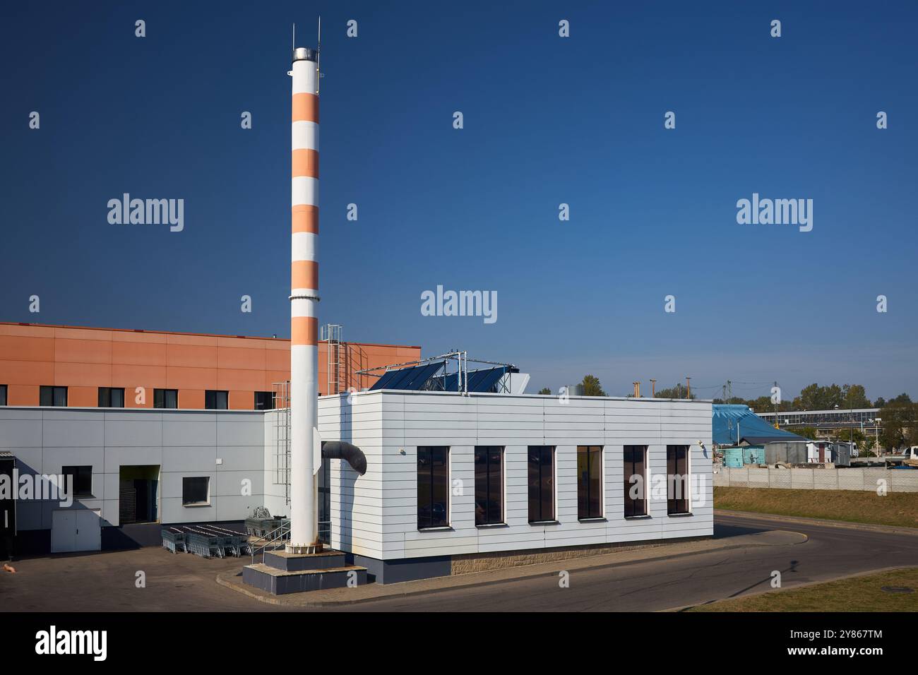 Modern boiler house building with steam pipes to provide heating and ...