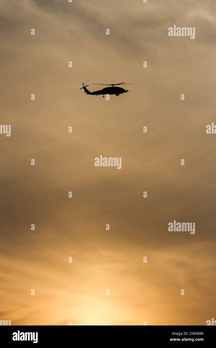 The silhouette of a US Navy Sikorsky SH-60R Seahawk helicopter with the ...