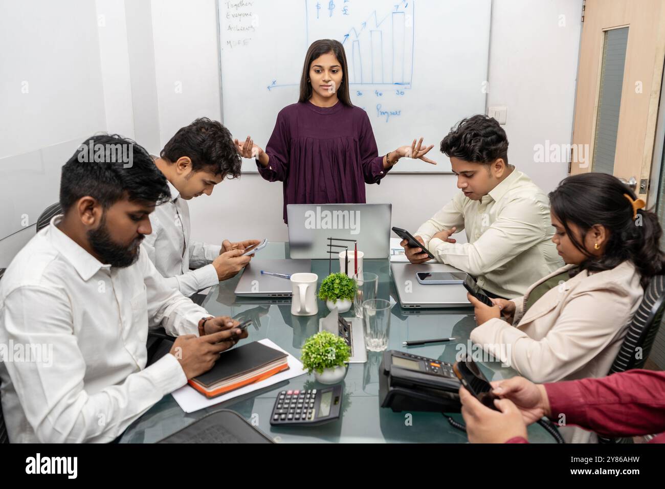 Capture the scene where a female boss enforces a cell phone ban in a ...