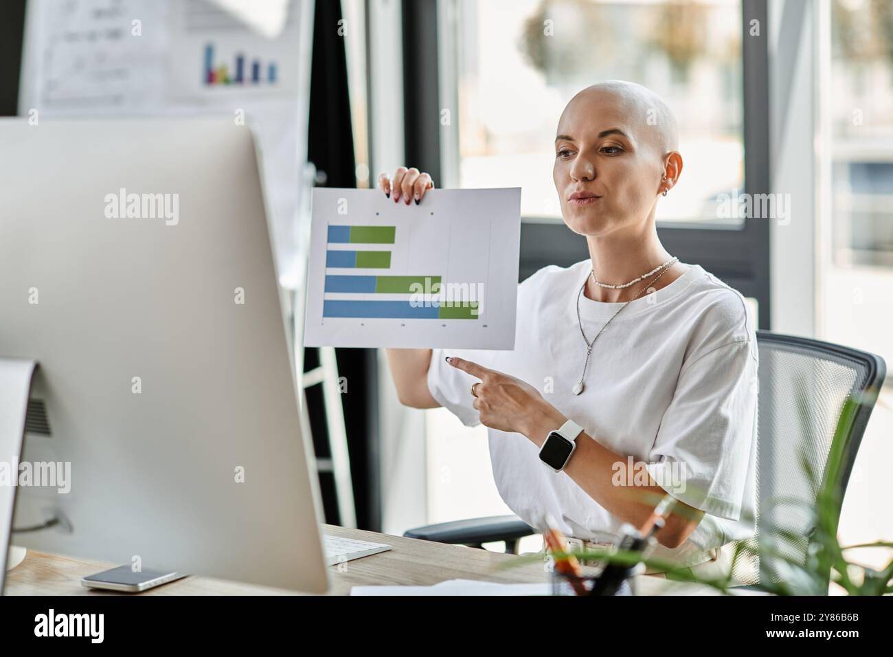 A young woman with a bald head shares insights on a graph while ...