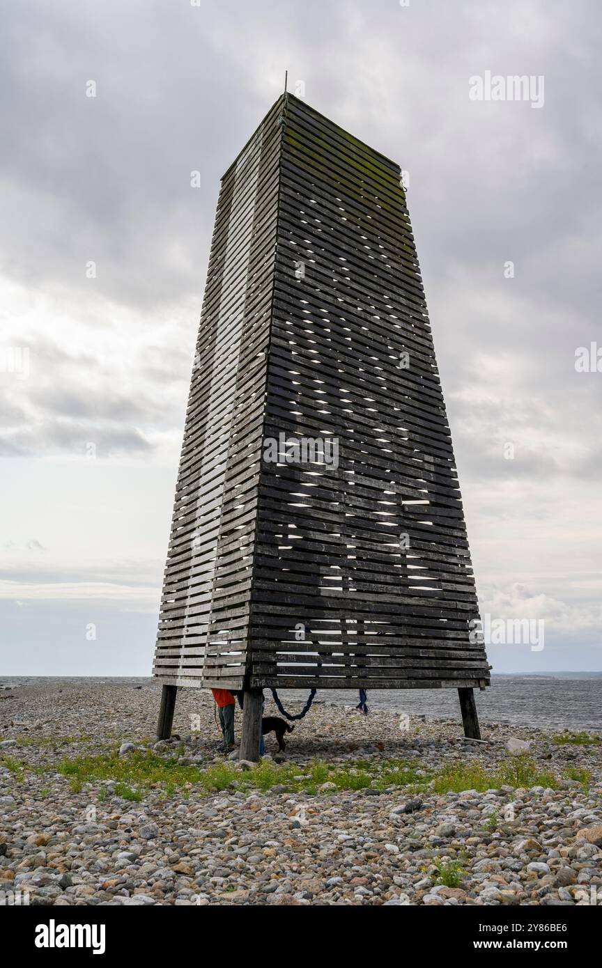 The sea mark or navigation mark on the flat, rocky beach at the ...