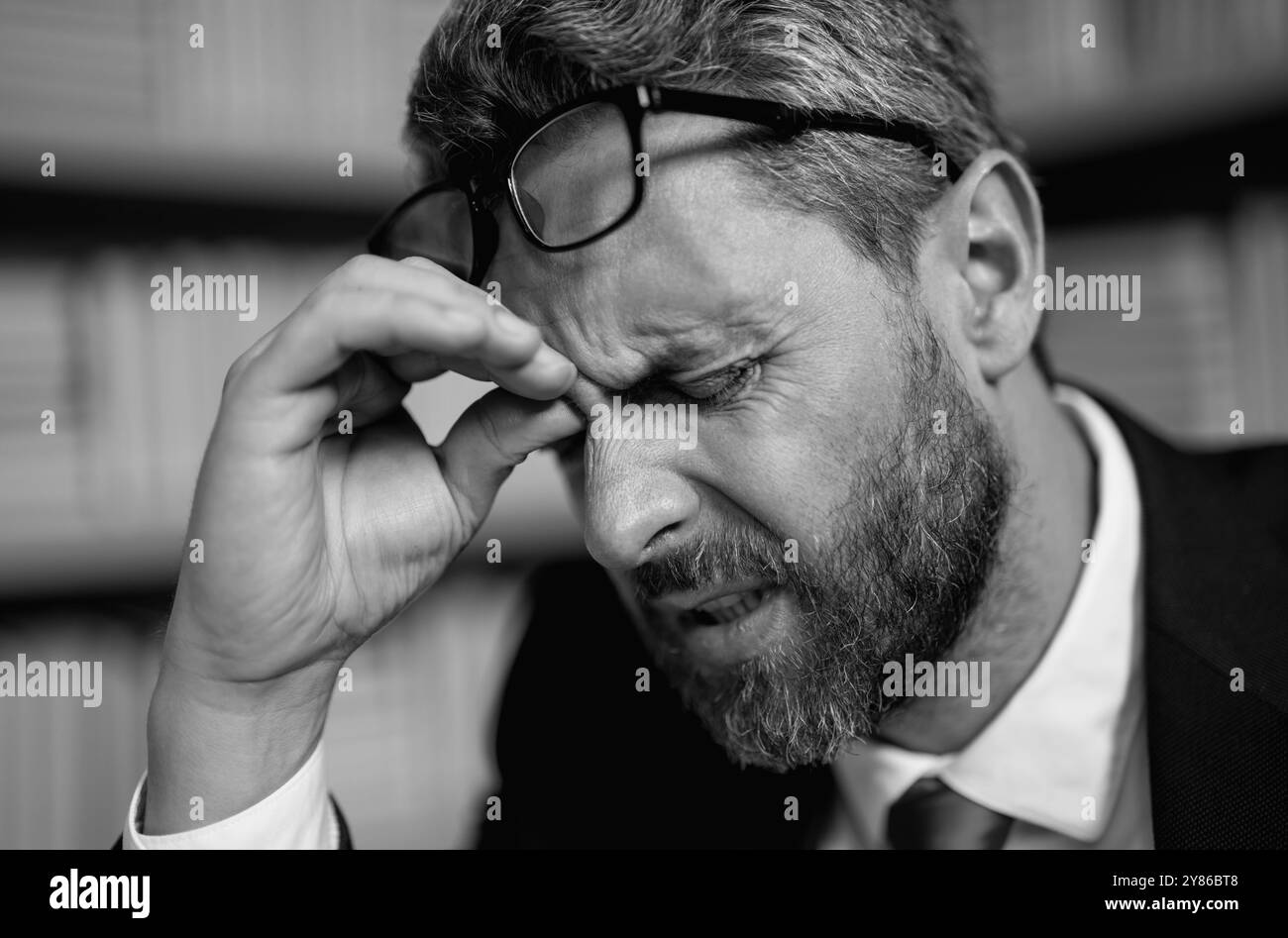 Close up face of stressed man with headache migraine. Overworked man ...