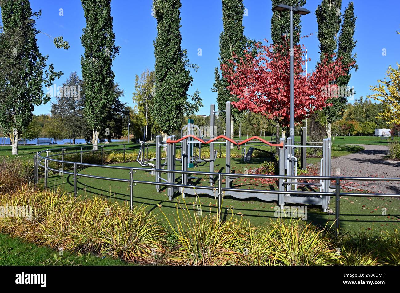 This photo shows an outdoor fitness area set in a well-maintained park ...