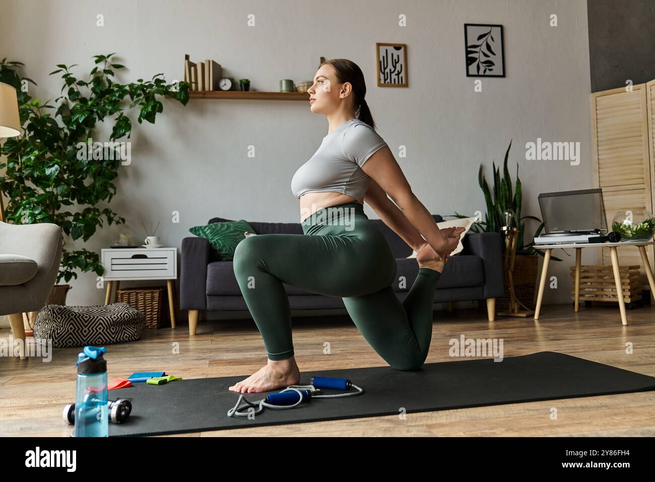 An energetic woman in athletic attire stretches deeply, engaging in a ...