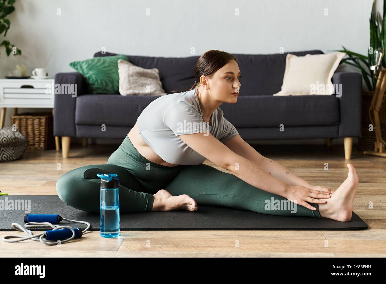 She stretches deeply on her mat, embracing a holistic workout routine ...