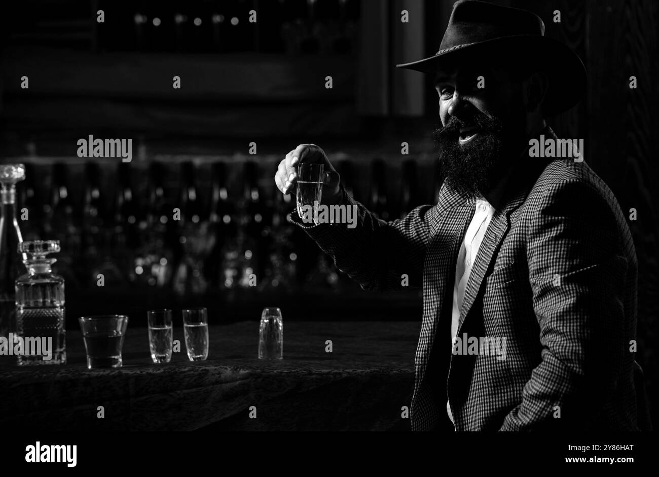 Serious unhappy sad man pouring vodka while having alcohol addiction ...