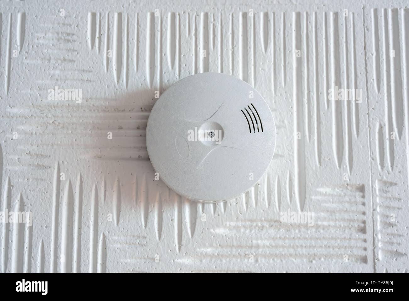 White ceiling mounted fire safety device smoke detector Stock Photo - Alamy