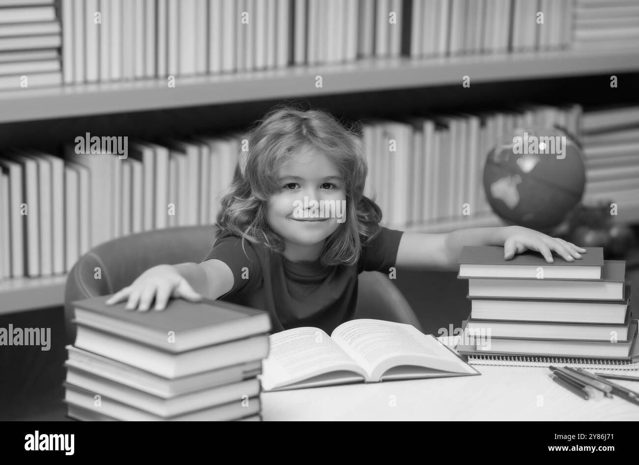 Smart pupil. School kid pupil studying in school library. Child reading ...