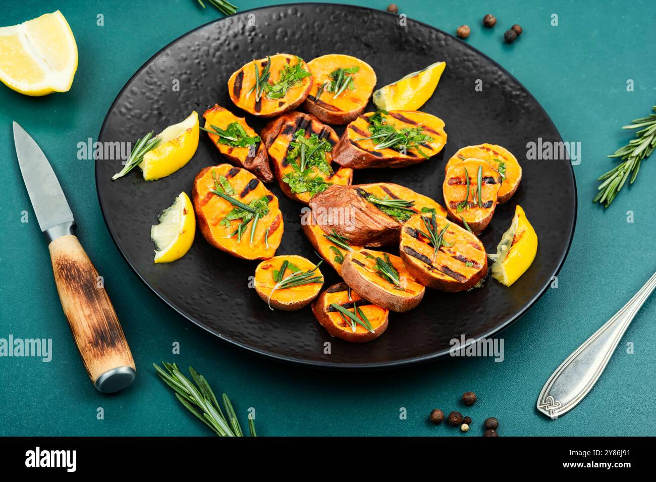 Tasty grilled sweet potato or yam pieces with olive oil and greens ...
