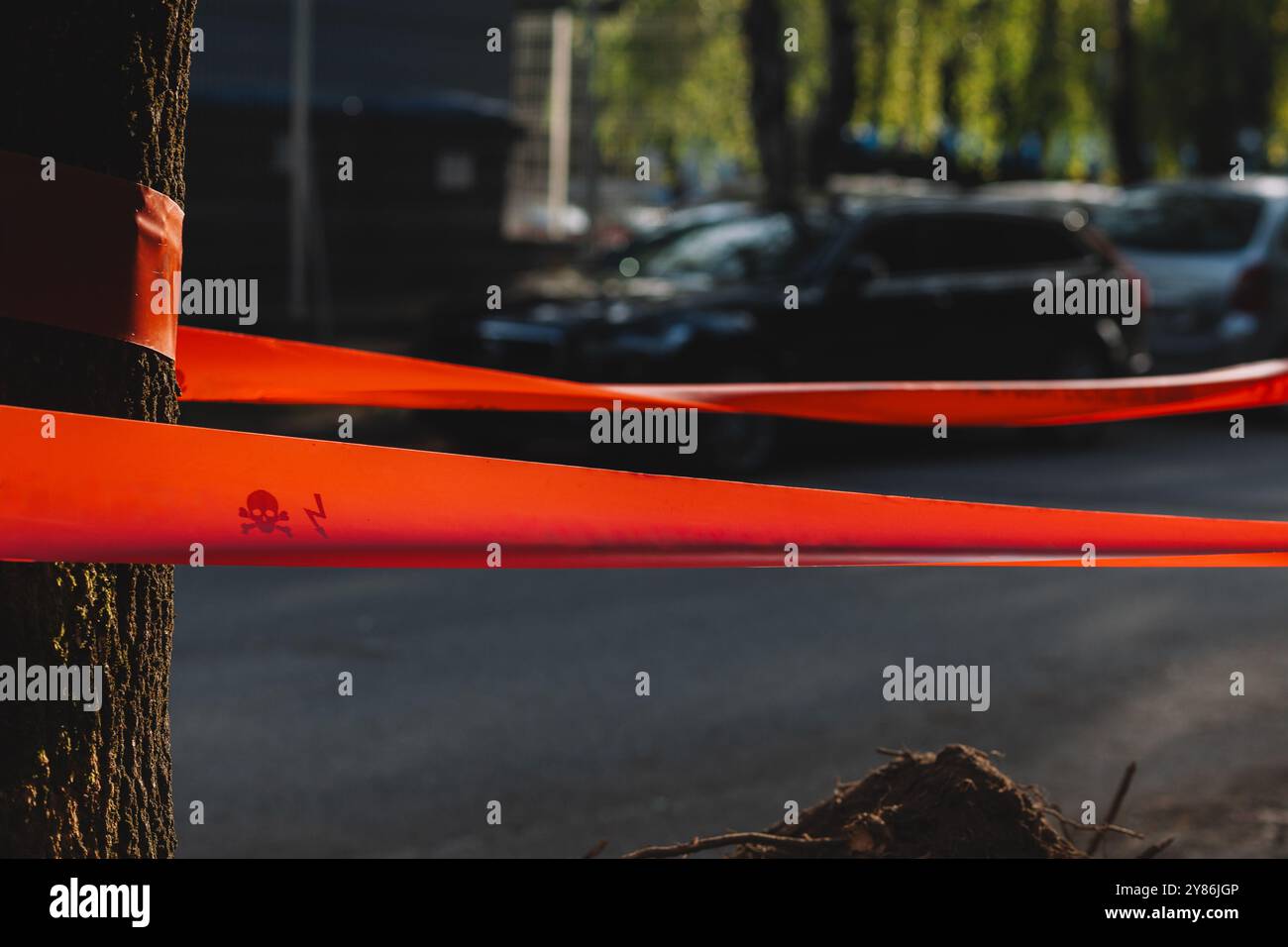 Close up of red warning tape with a skull and crossbones symbol wrapped ...