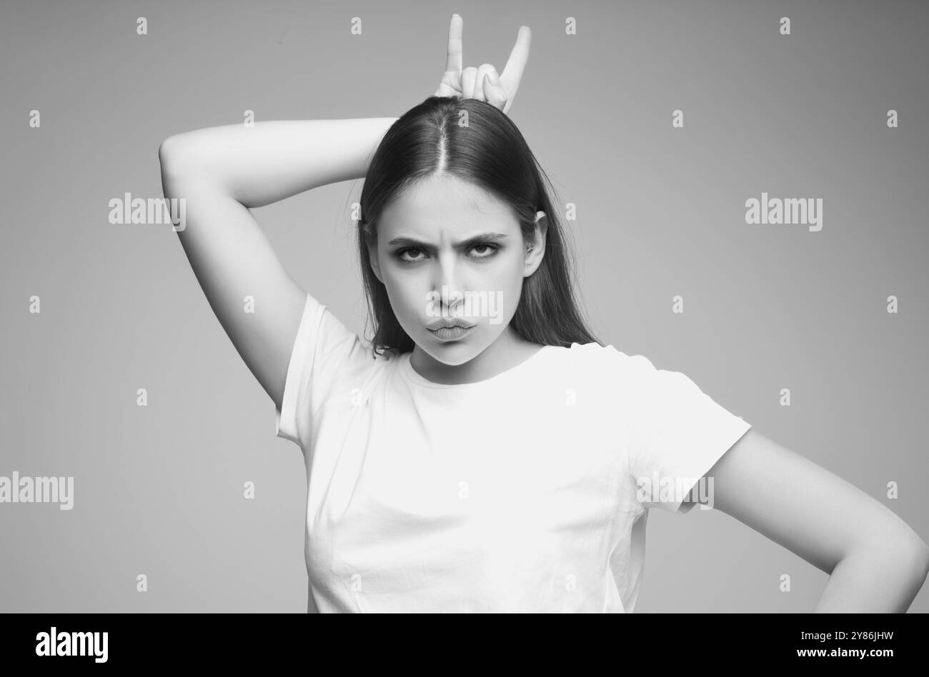 Woman with finger horn and angry expression. Angry hateful girl furious ...