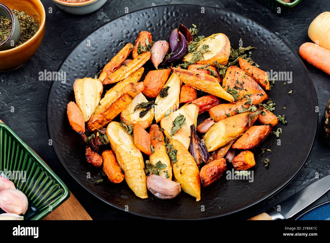 Vegan food of baked parsnip root and carrots. Roasted root vegetables ...
