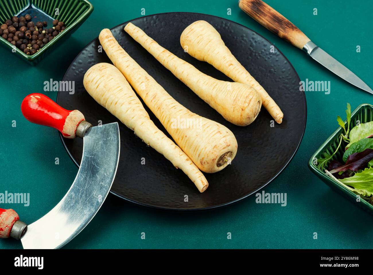 Raw parsnip roots on the kitchen table. Root vegetables. White root ...