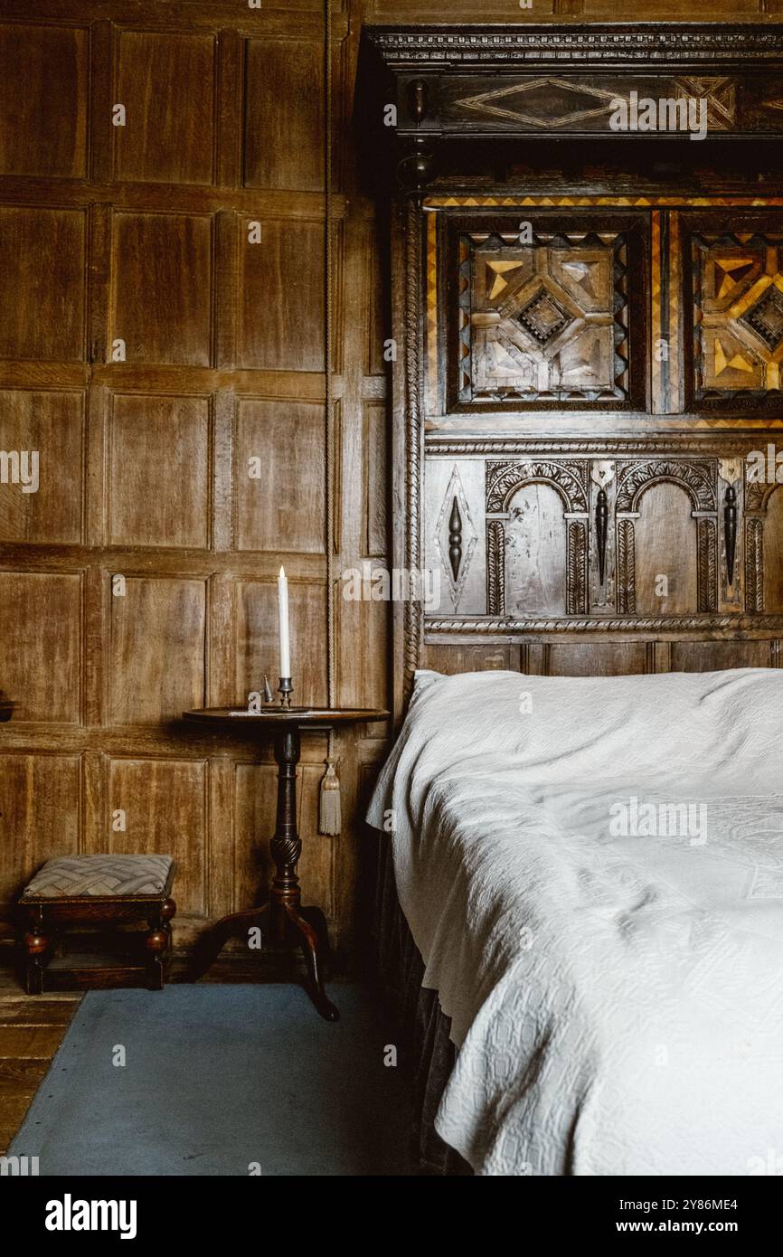 Historic carved bed head and wooden panels in an English manor house ...